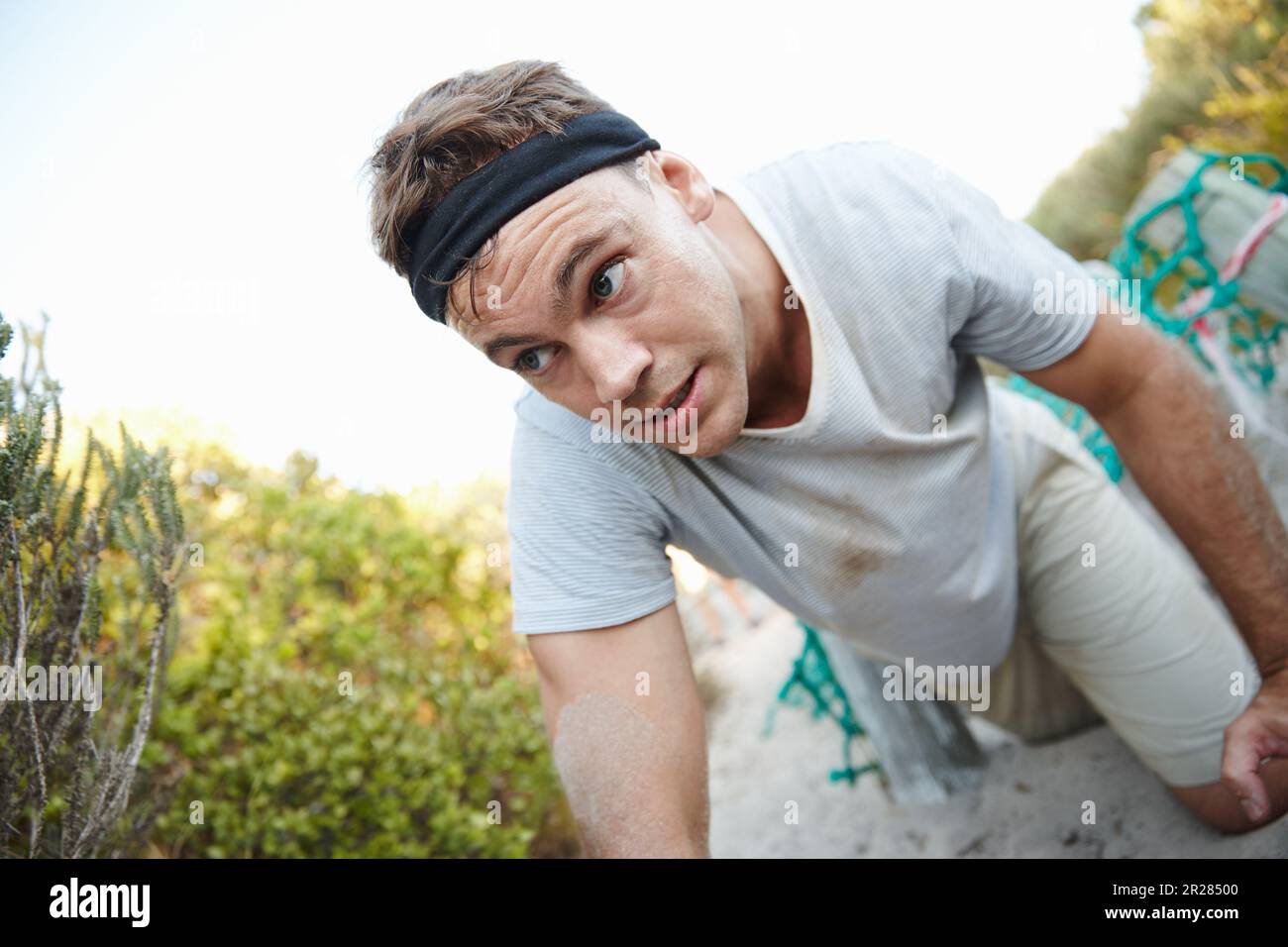 Beyond tired but too stubborn to care. a man going through an obstacle ...