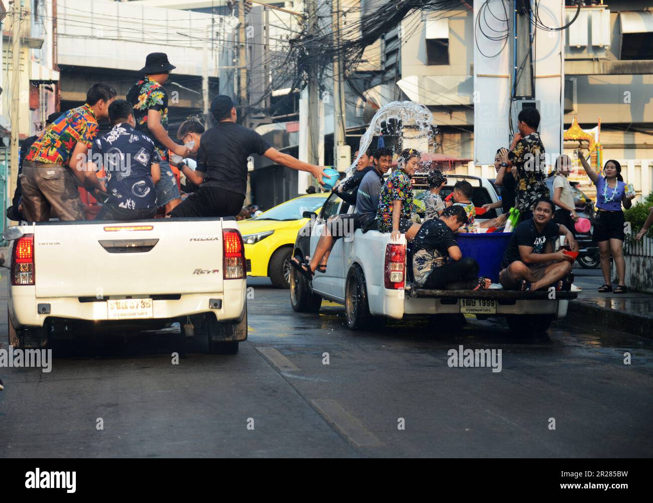 Local Thai people celebrating Songkran by splashing water from the back ...