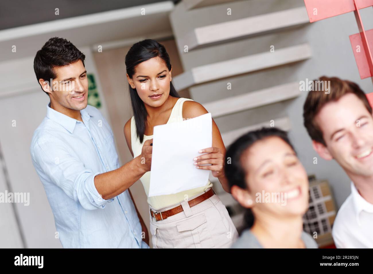 Giving her pointers. Two creative directors discussing a project brief ...