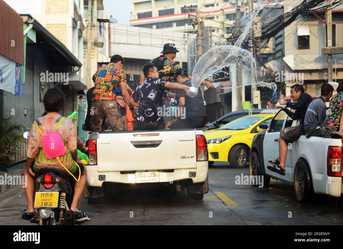 Local Thai people celebrating Songkran by splashing water from the back ...