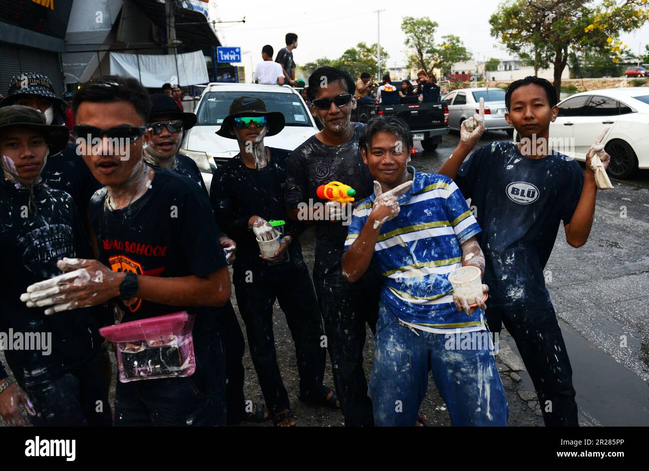 Local Thai people celebrating Songkran by splashing water from the back ...