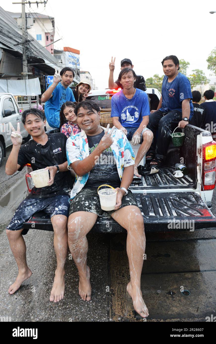 Local Thai people celebrating Songkran by splashing water from the back ...
