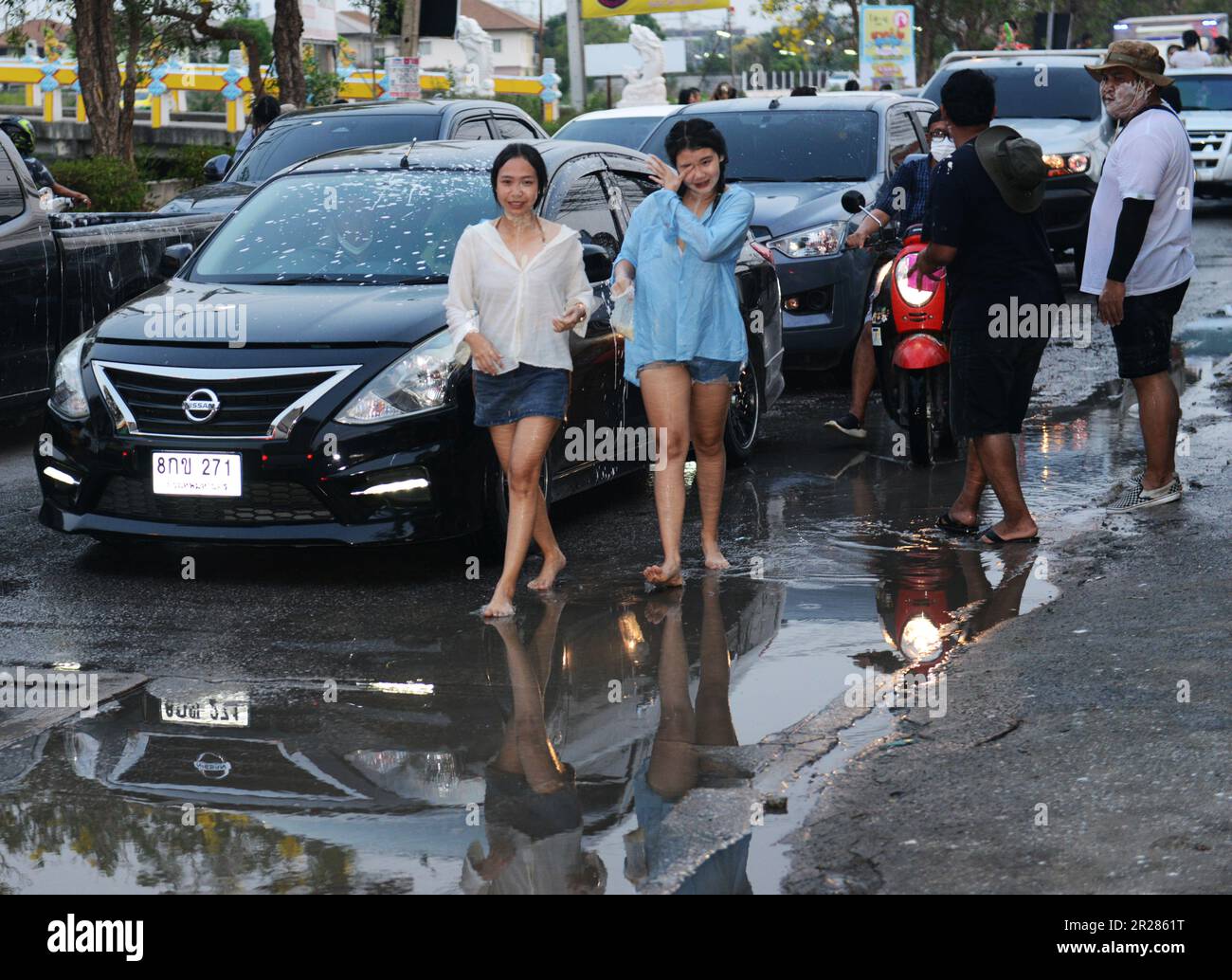 Local Thai people celebrating Songkran by splashing water from the back of pickup trucks ...