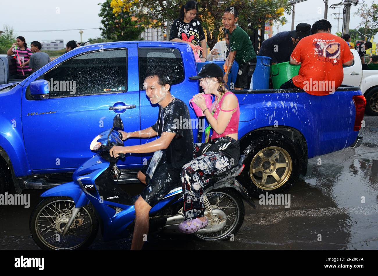 Local Thai people celebrating Songkran by splashing water from the back ...