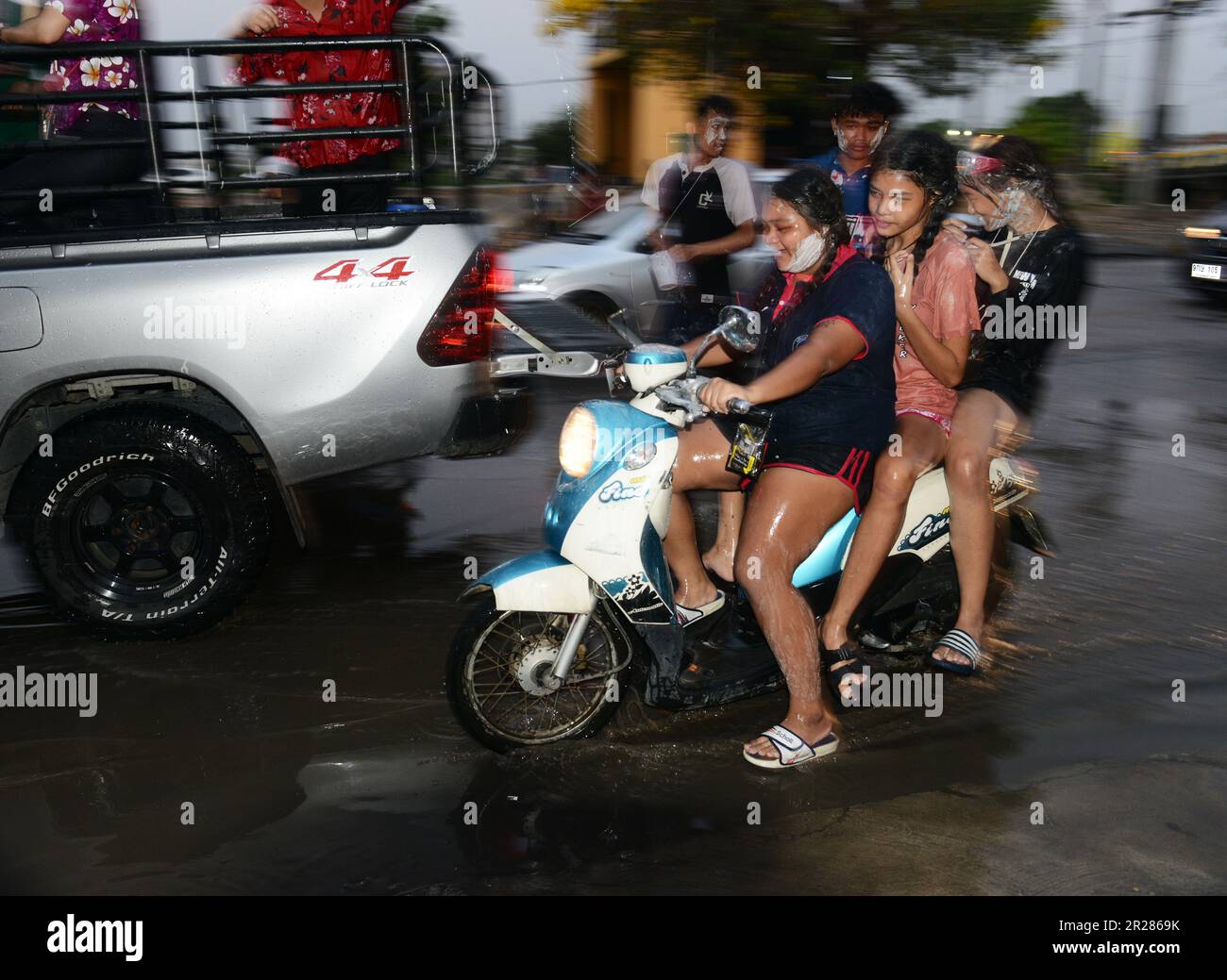 Local Thai people celebrating Songkran by splashing water from the back ...
