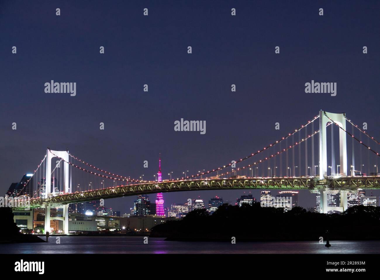 Rainbow Bridge lit up in pink and Tokyo Tower Stock Photo - Alamy