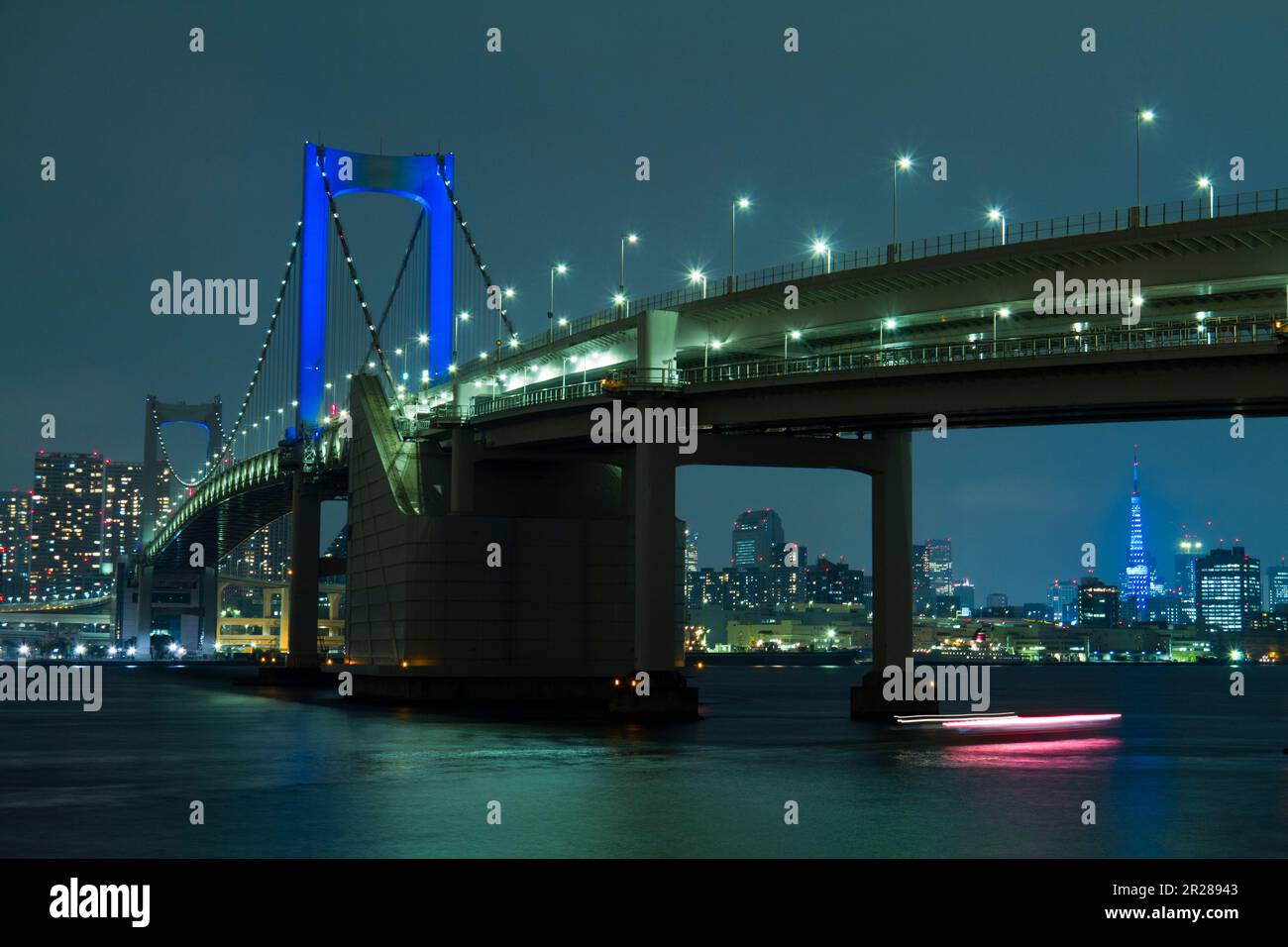 Rainbow Bridge lit up in blue and Tokyo Tower Stock Photo - Alamy