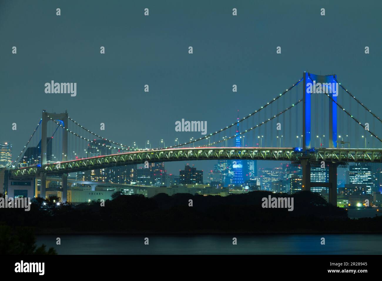 Rainbow Bridge lit up in blue and Tokyo Tower Stock Photo - Alamy