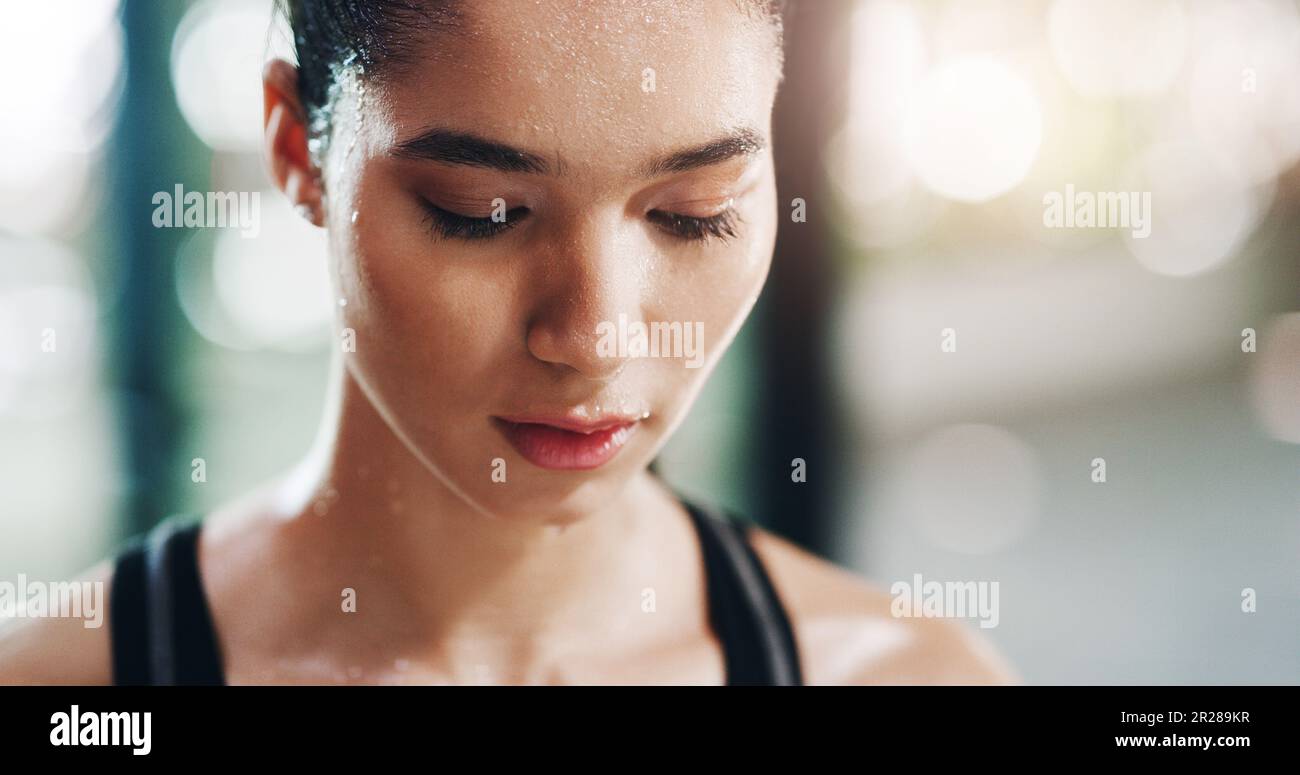 Fitness, workout and female athlete sweating in the gym after sports ...