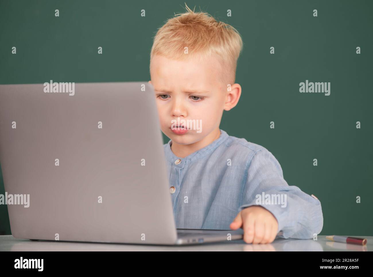 Serious concentrate child using laptop computer, kid boy studying ...
