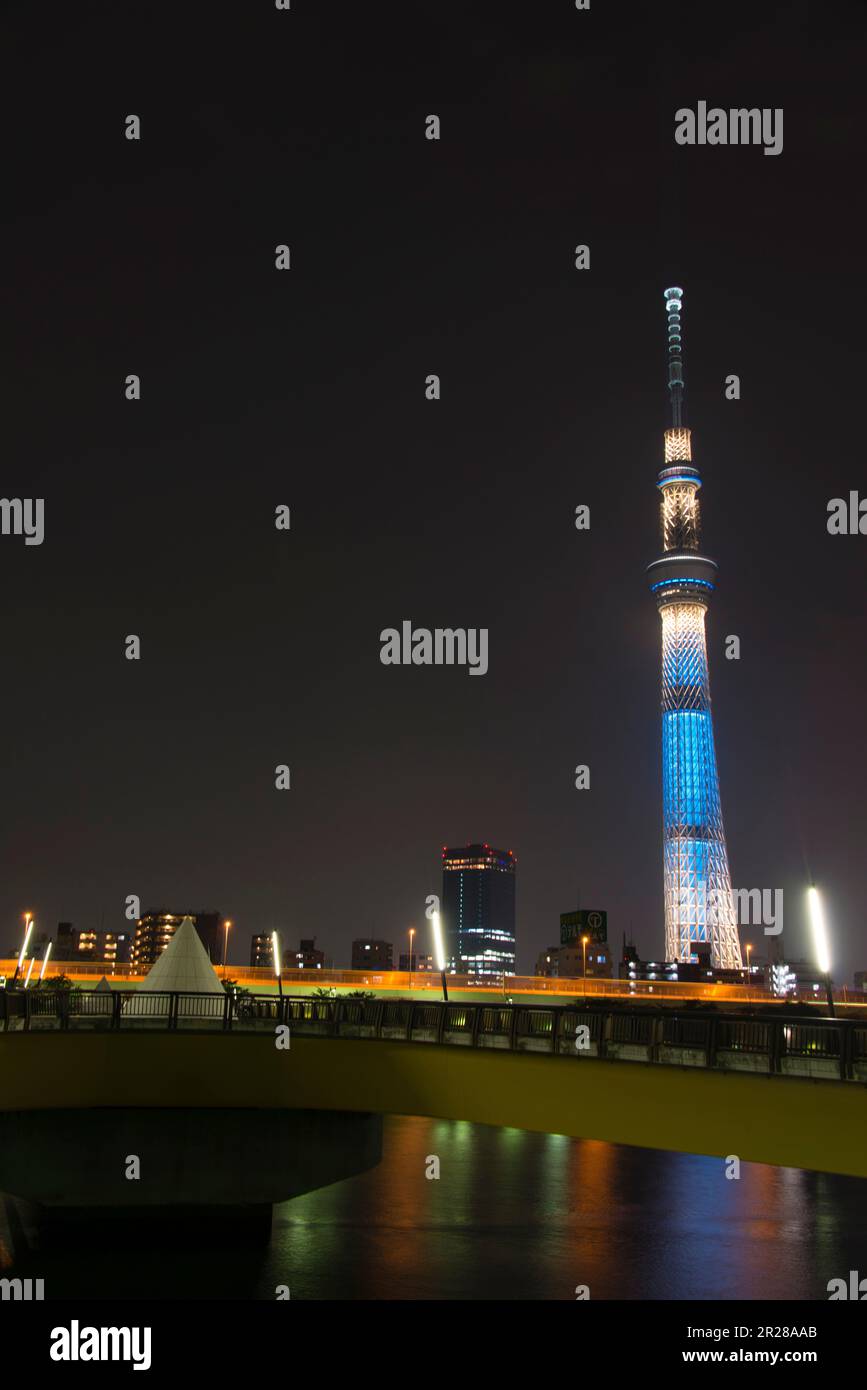 Tokyo Sky Tree lit up (Trendy) viewed vertically from Sakurabashi Stock ...