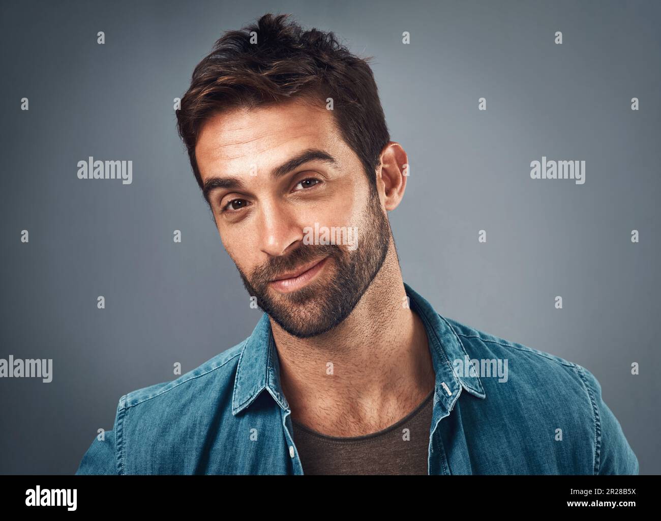 Unshaven but still as smooth as ever. Studio portrait of a handsome ...