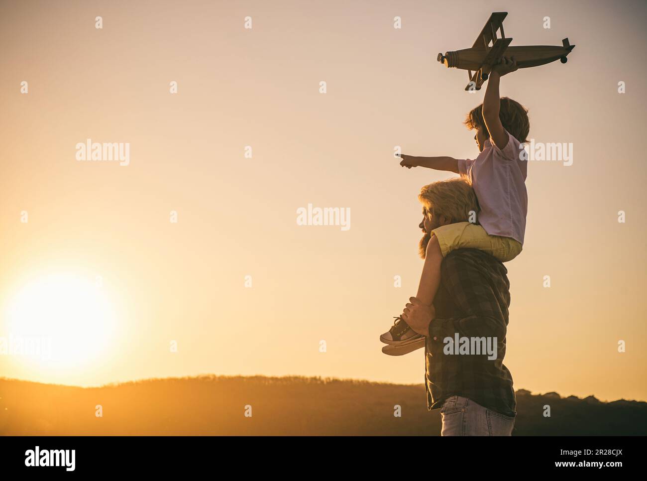 Happy child. Sunset silhouette of Father and son together. Boy child is ...