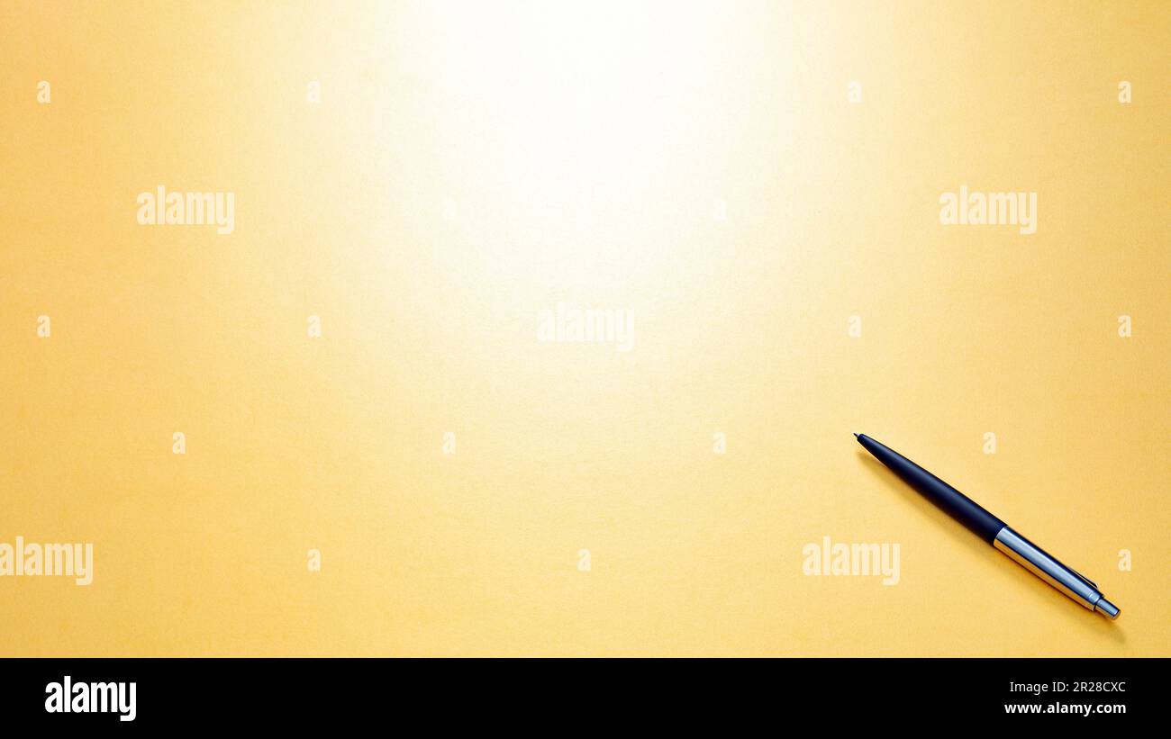 Classic ballpoint pen on golden textured paper Stock Photo - Alamy