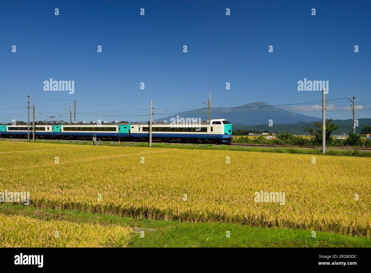 Limited express train Inaho running along JR Uetsu main line, Mount ...