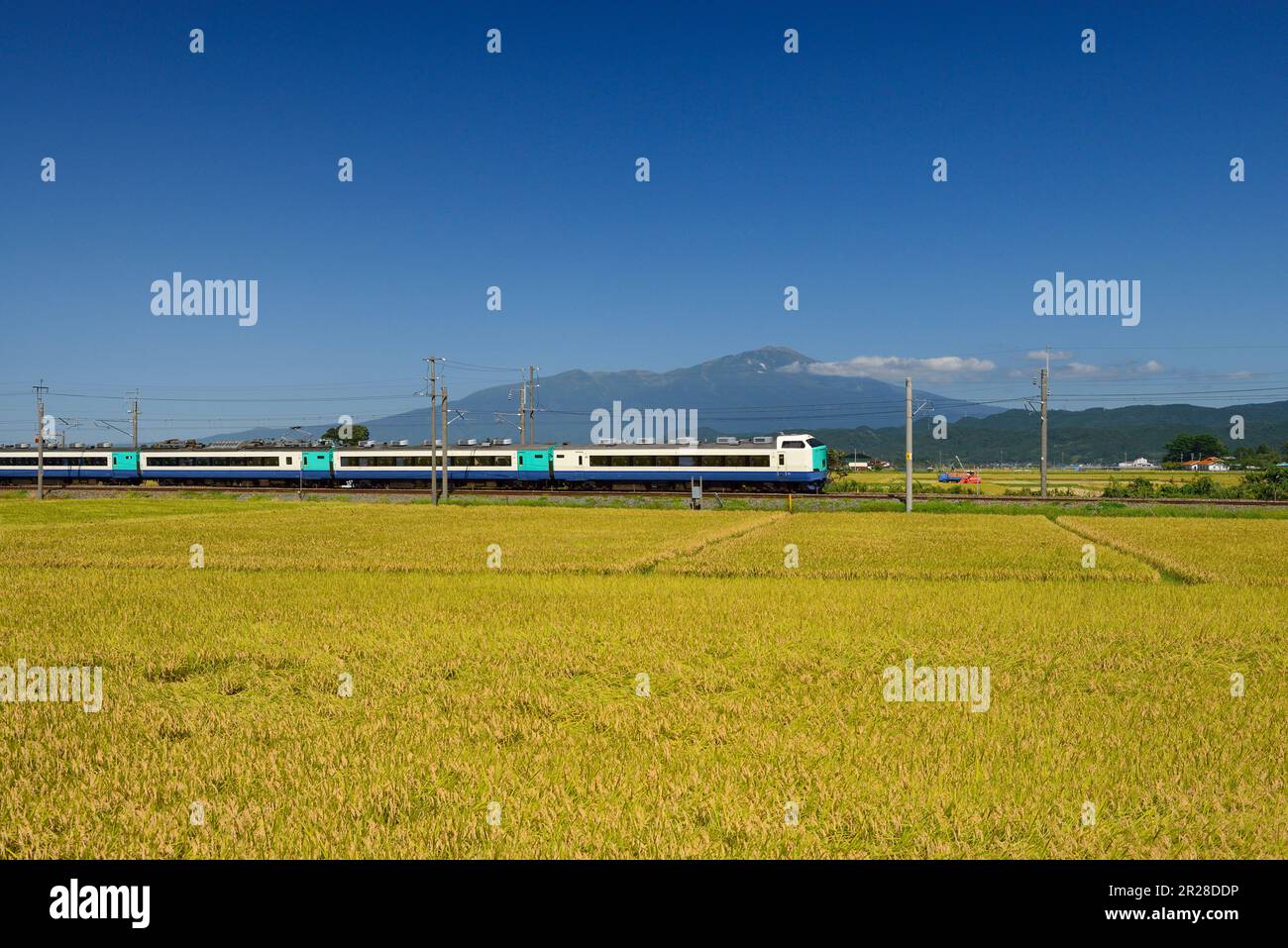 Limited express train Inaho running along JR Uetsu main line, Mount ...