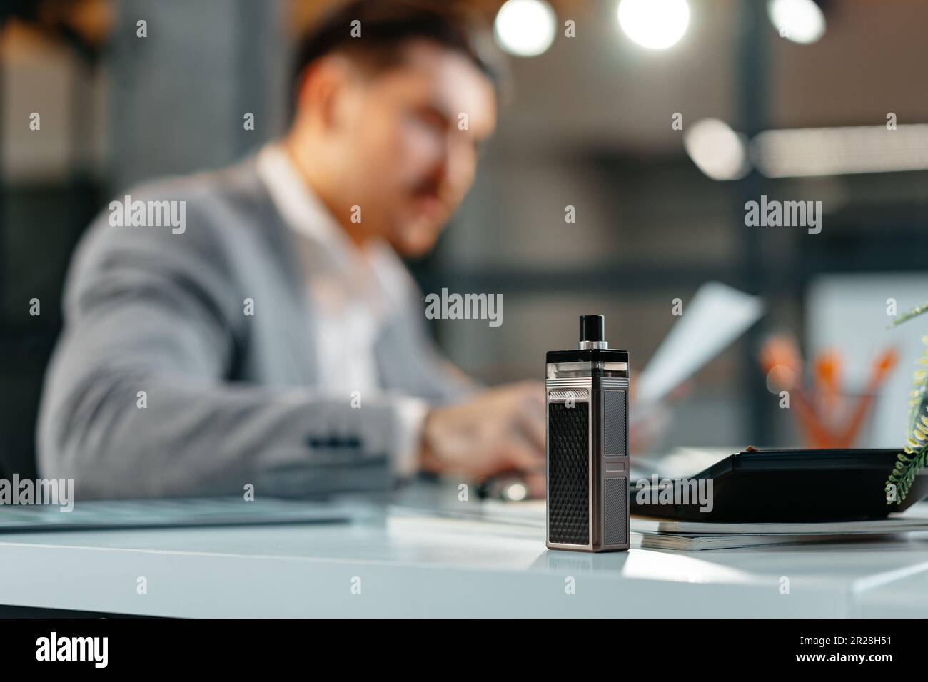 Vape on the working table of a male businessman Stock Photo - Alamy