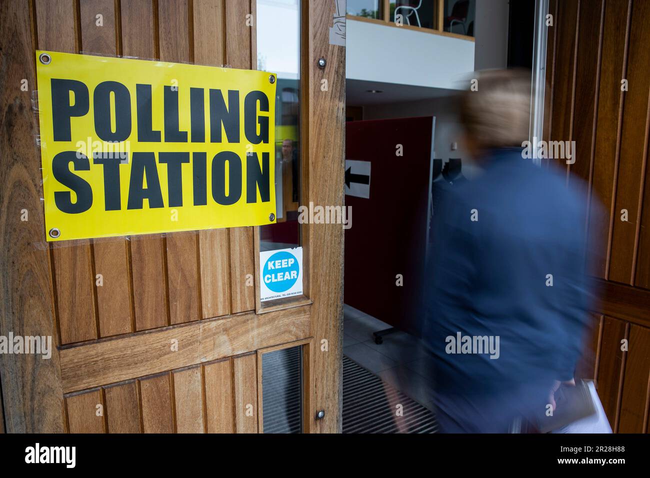 A person walks past polling station sign as the polling station at the ...