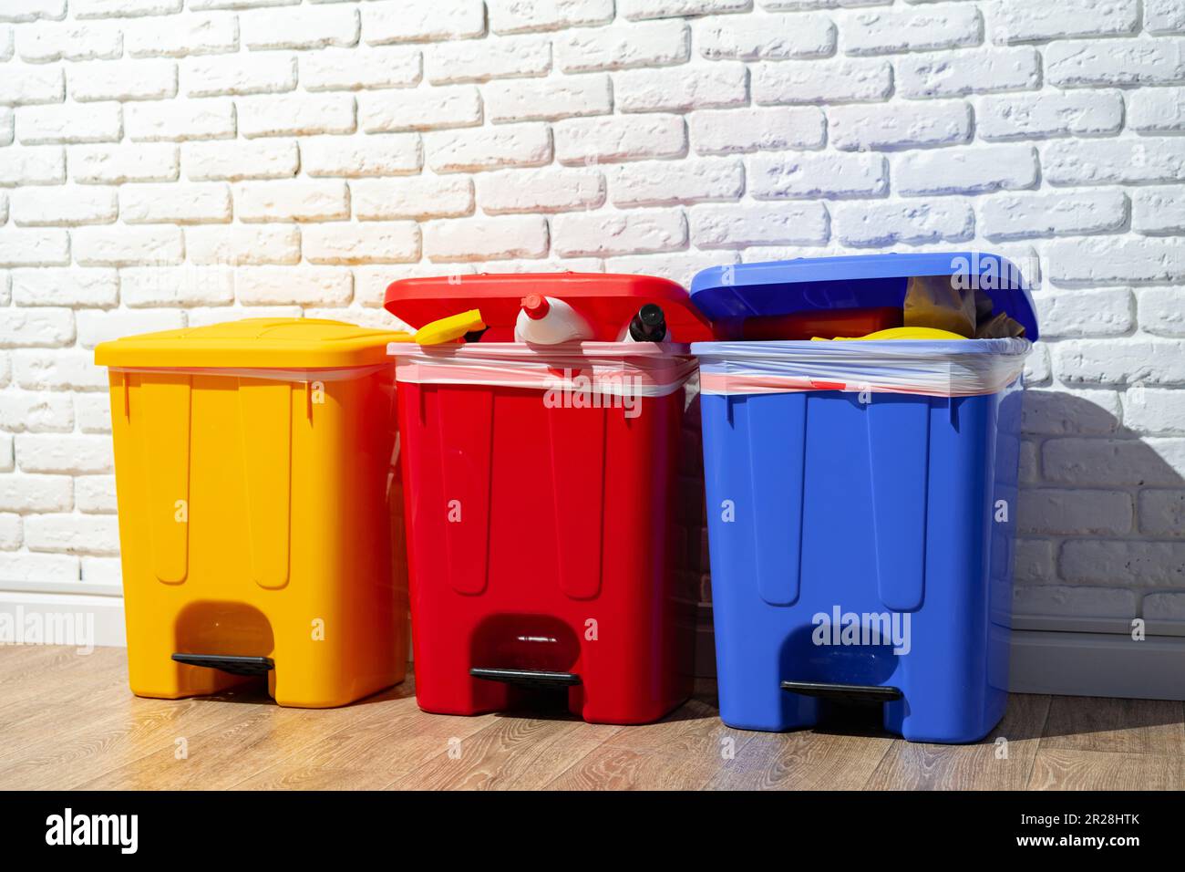 Trash cans full of waste in the building Stock Photo - Alamy