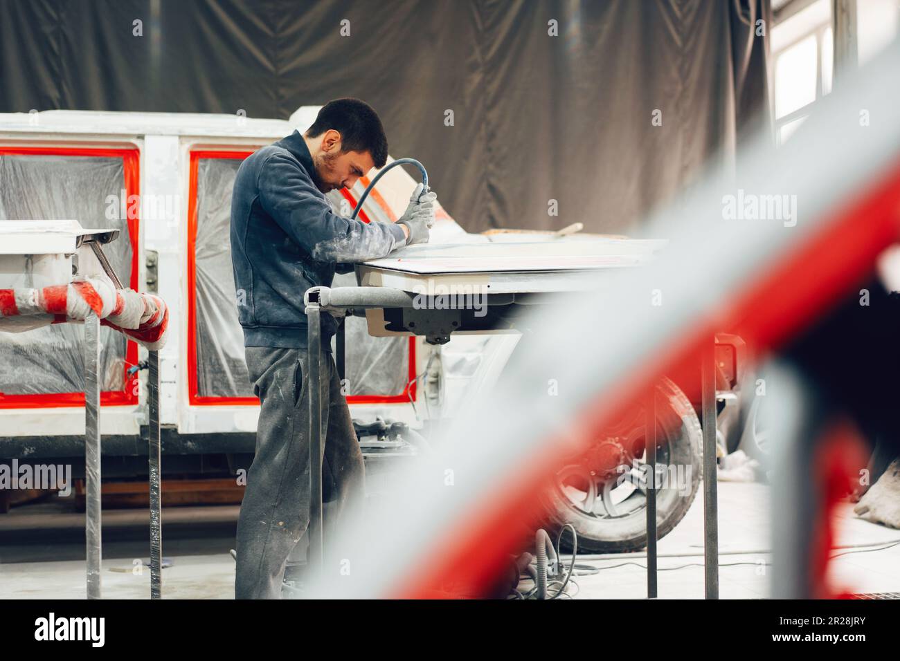 Auto mechanic straightening car body in car service station Stock Photo ...