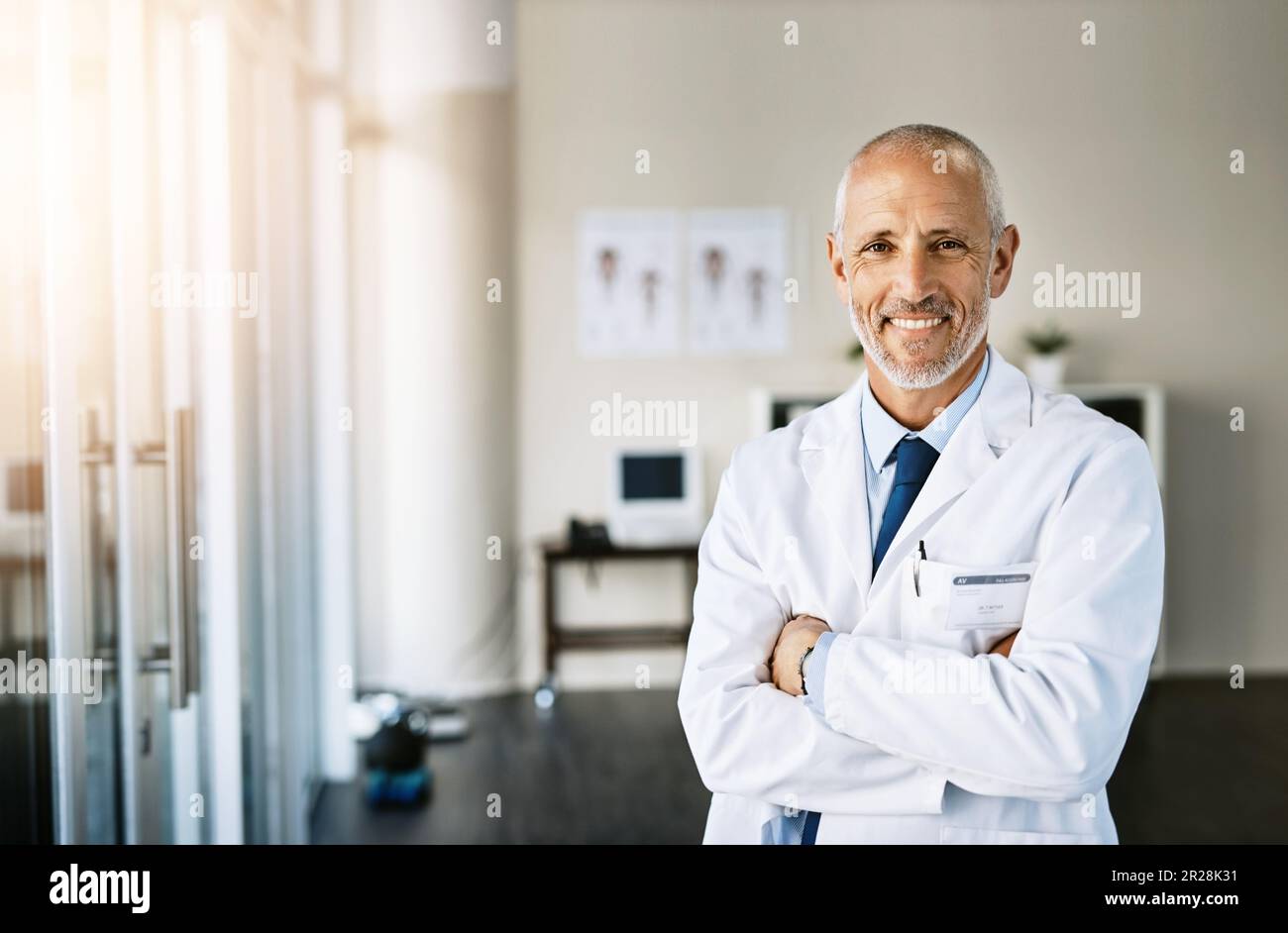 Mature doctor, smile and portrait with arms crossed in hospital feeling ...