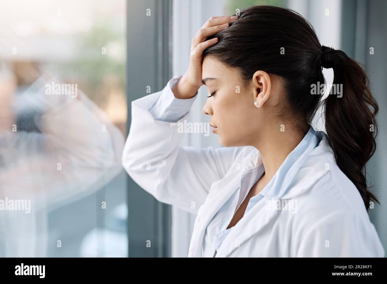 Stress, sad doctor and woman by hospital window with worry, anxiety and ...