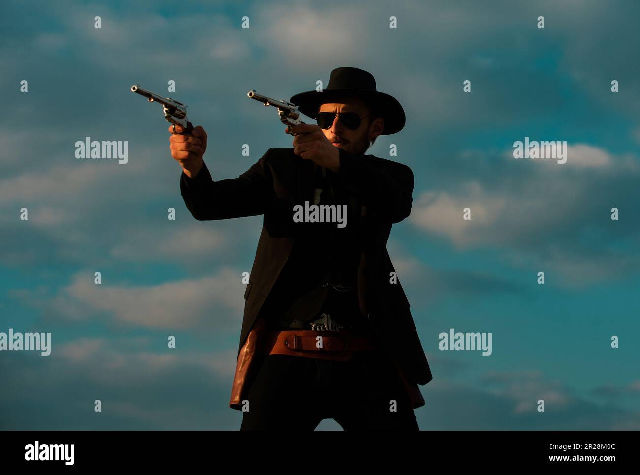 Cowboy shooting. Sheriff officer in black suit and cowboy hat. Man with ...