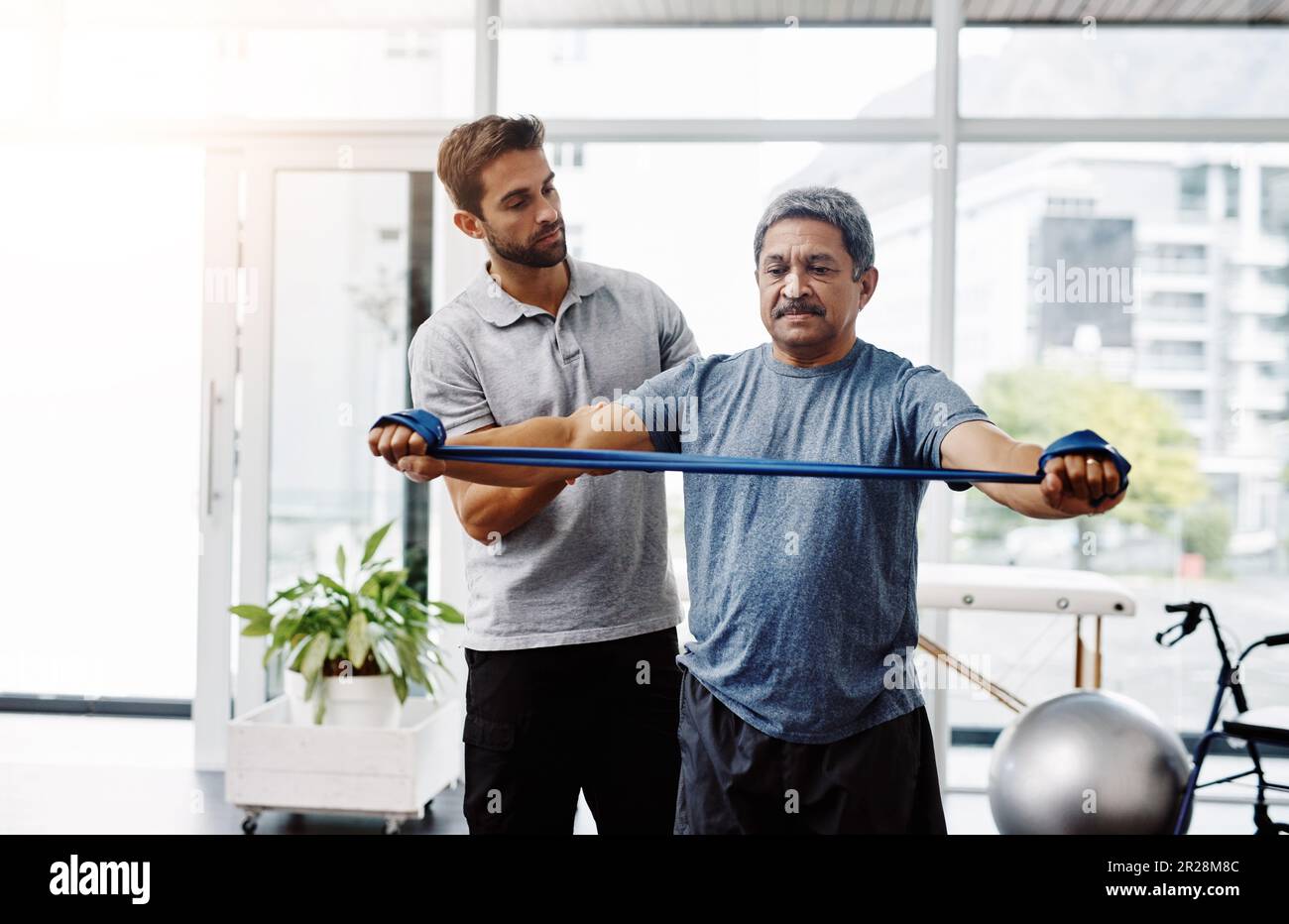Physiotherapy, rehabilitation and band with old man and doctor for ...