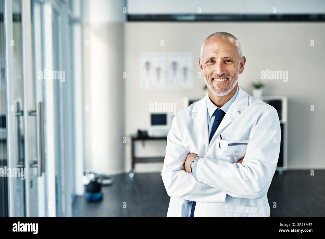 Mature doctor, worker and portrait with arms crossed in hospital ...