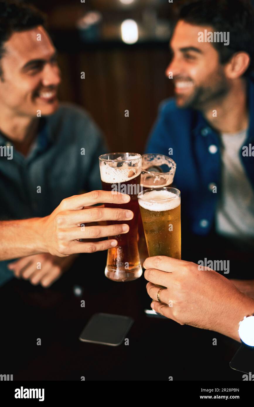 Beer, cheers and man hands drinking with friends at social event in a ...