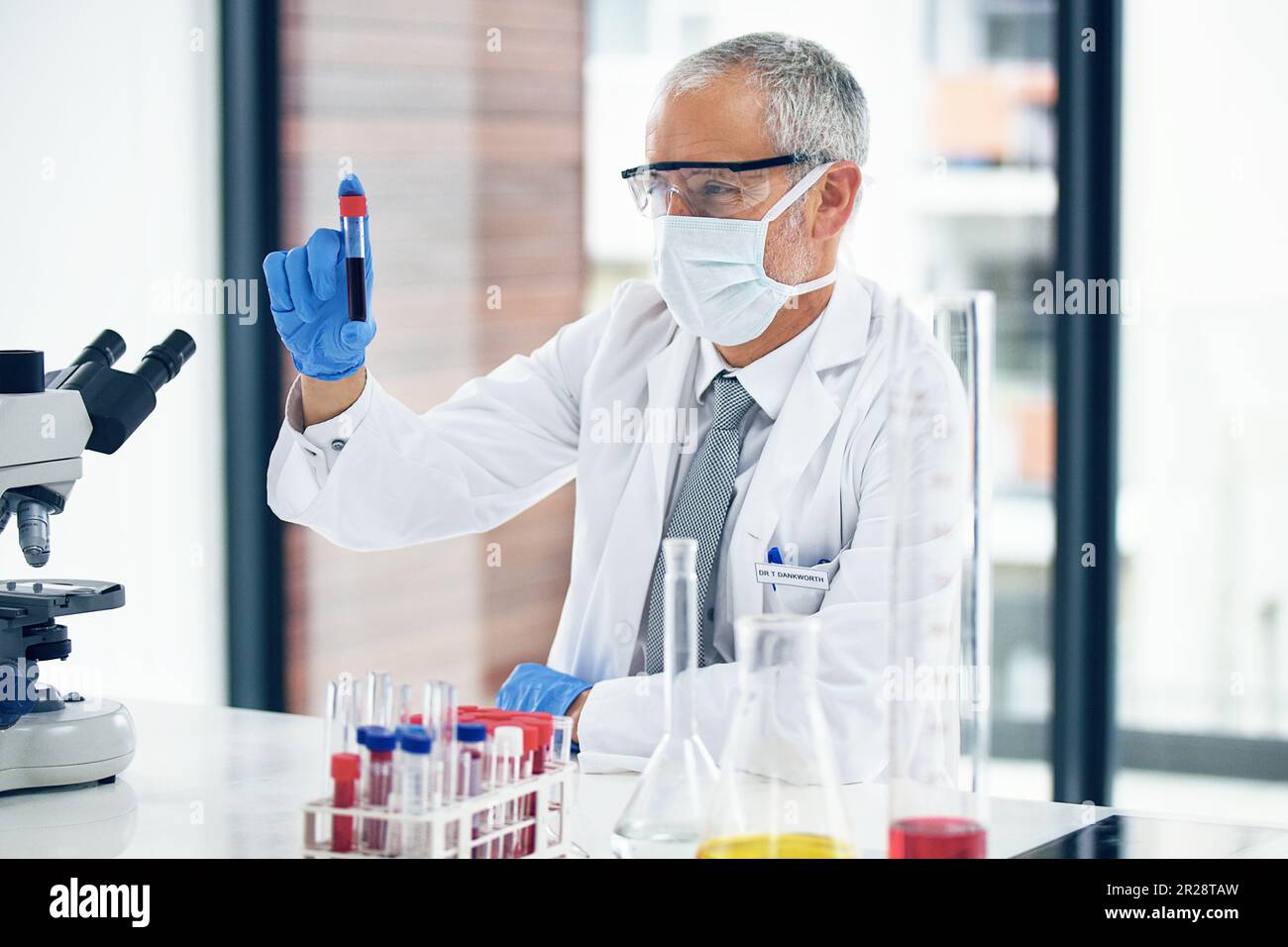 Science, scientist and doctor with a vaccine in a blood test with ...