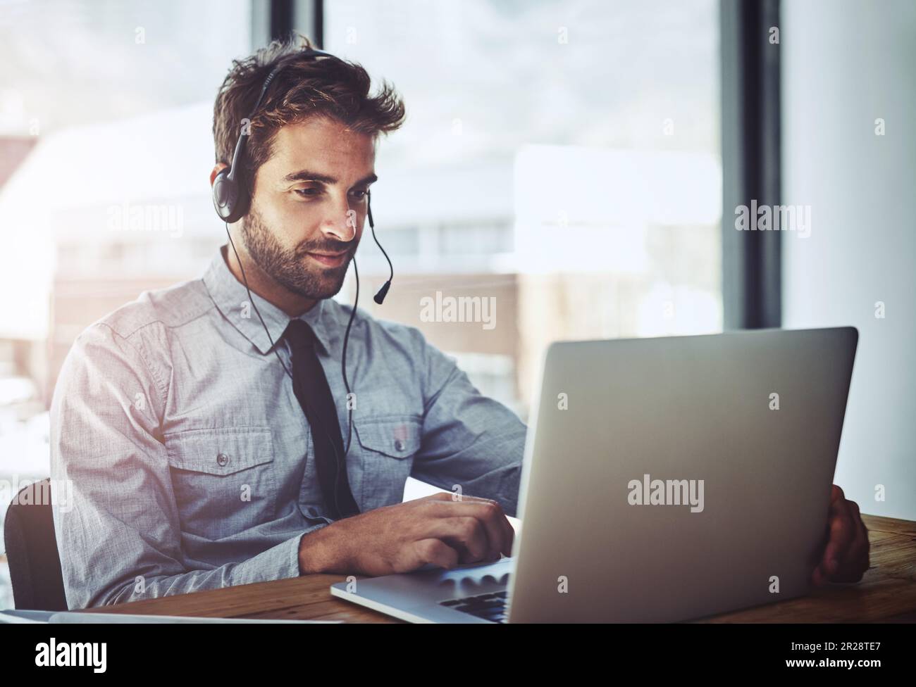 Man, call center and listen with laptop in office, help desk or talking ...