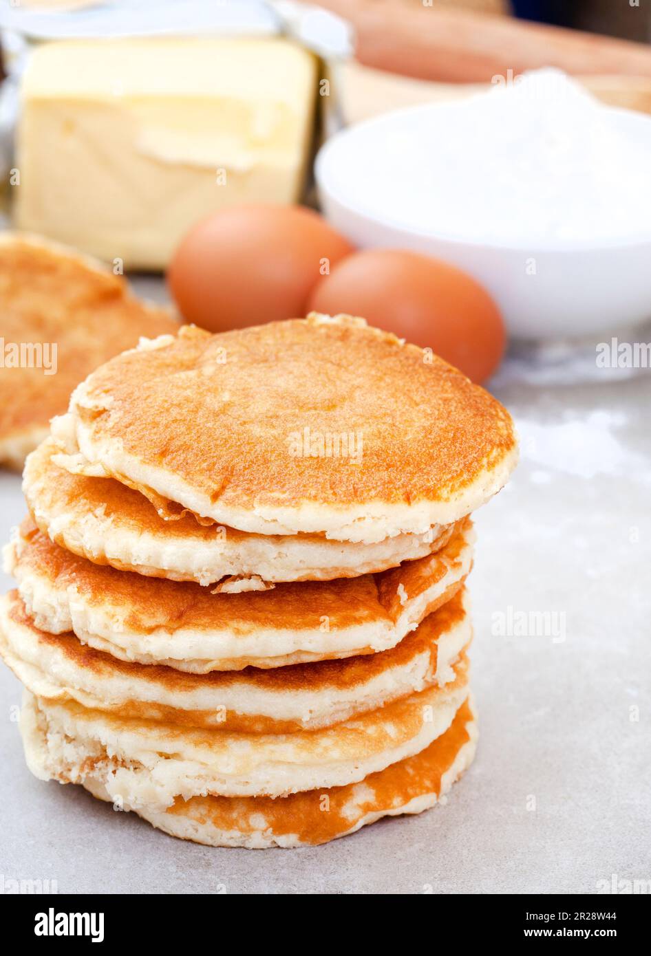 Fresh Pancakes stacked on kitchen table with syrup dripping down Stock ...