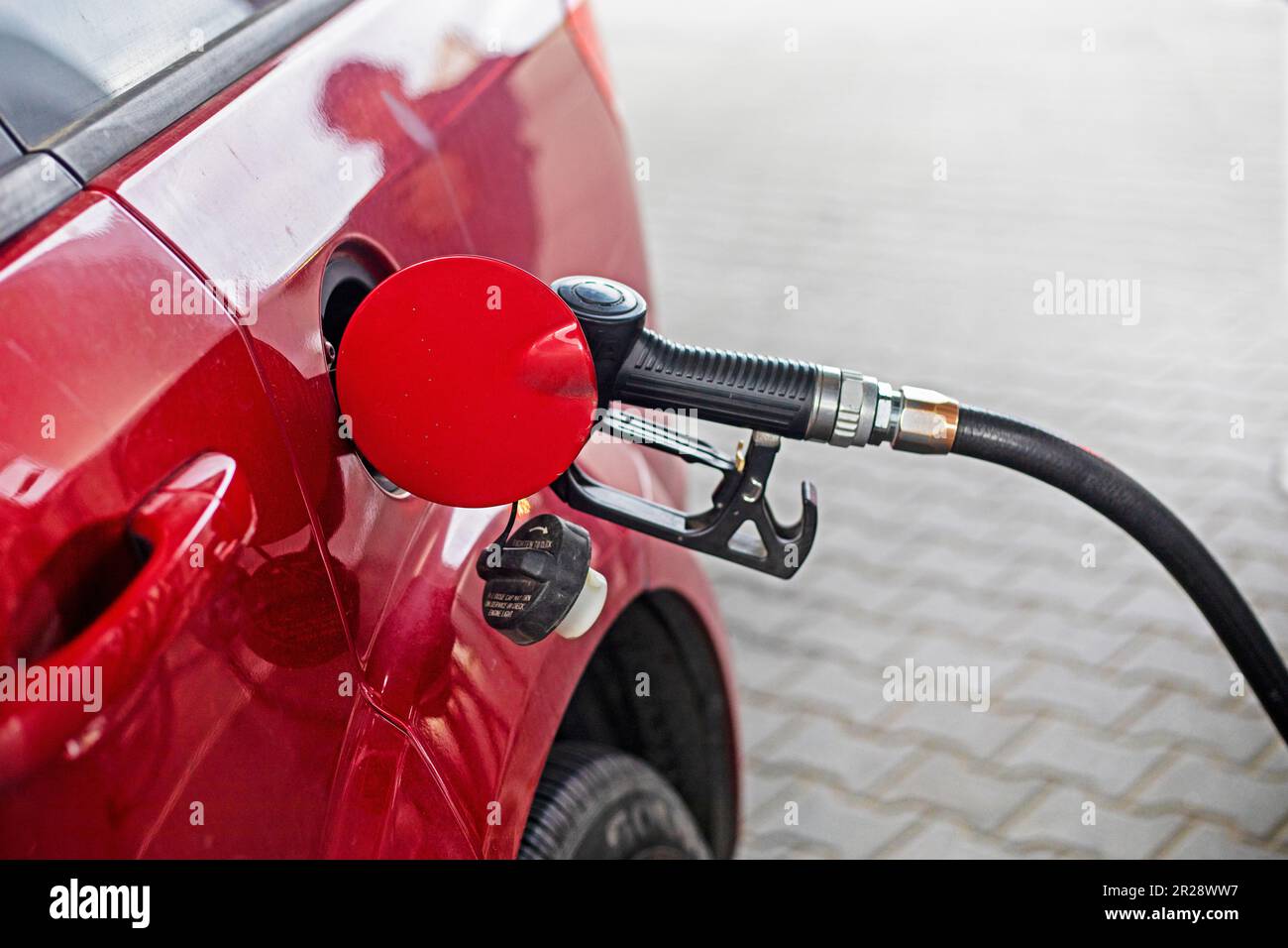 fill the red car with gasoline at the gas station. The economic crisis ...