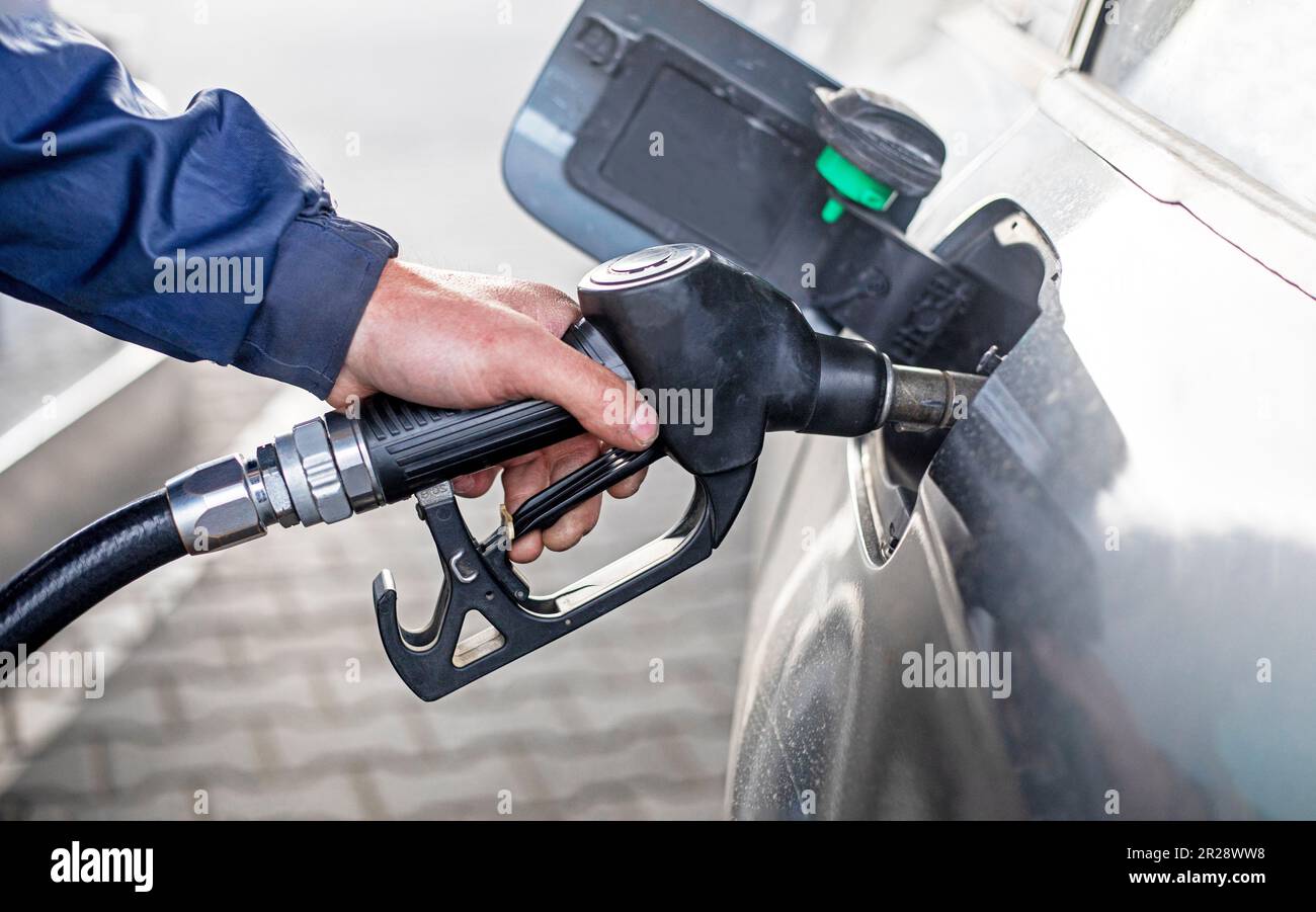 Refueling the car at a gas station fuel pump. Man hand refilling and ...