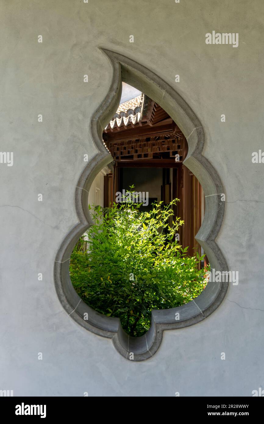 View of courtyard through leaf shaped window Stock Photo - Alamy