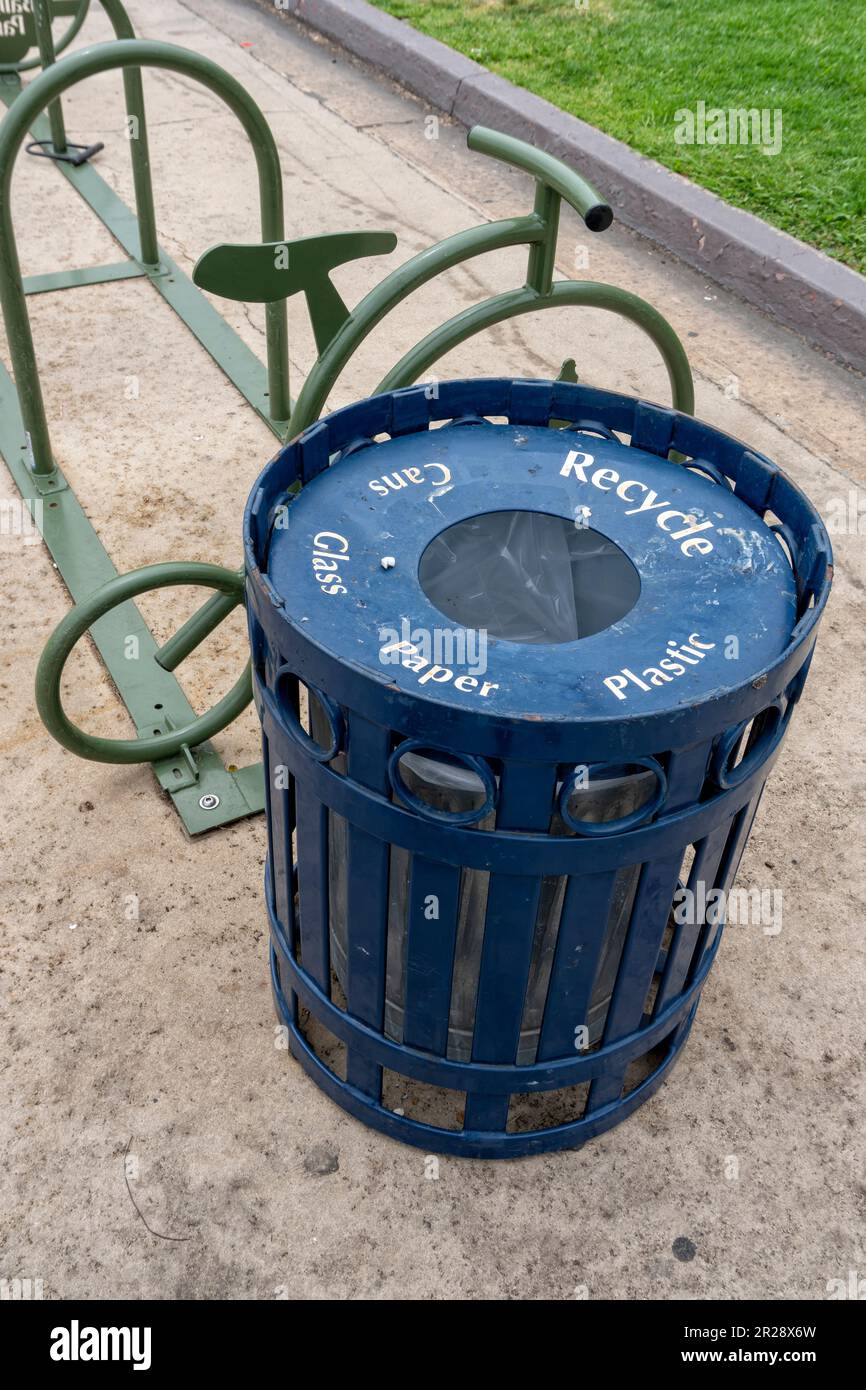 Blue metal recycle bin and bike rack in the park Stock Photo - Alamy