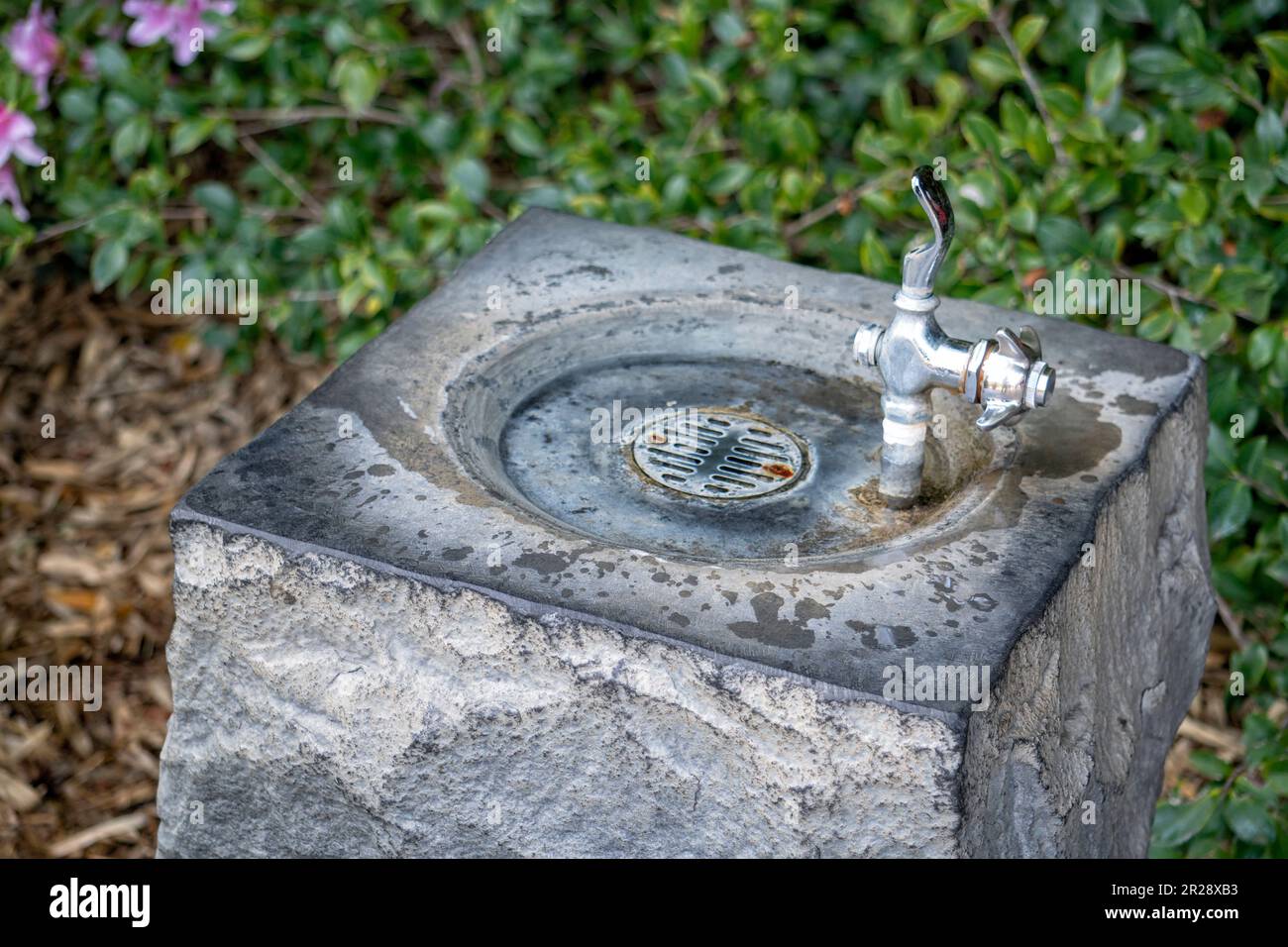 Close up of a natural stone drinking fountain Stock Photo - Alamy