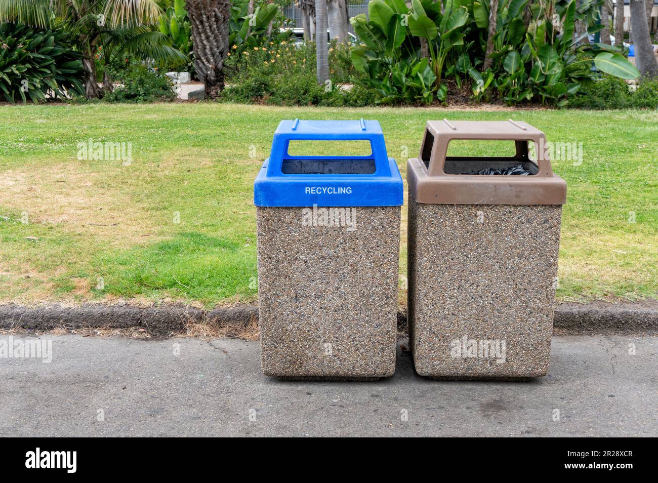 Square concrete recycle and trash receptacles with plastic lid in the ...
