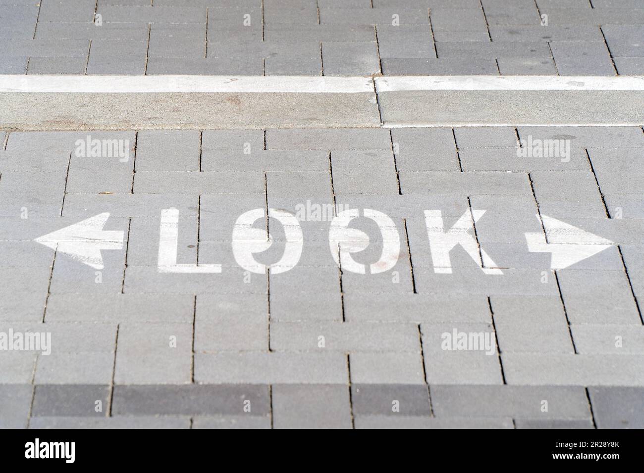 Look sign on the sidewalk Stock Photo - Alamy