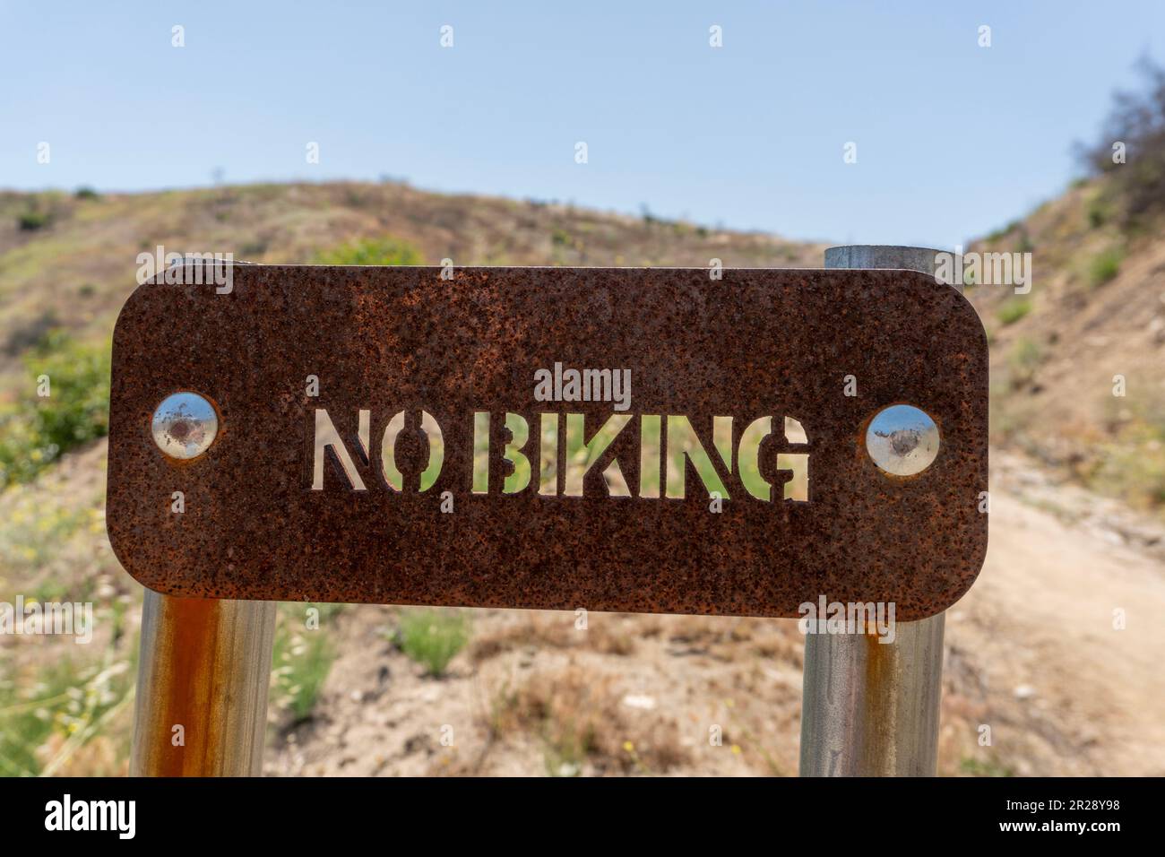 Rusted no biking sign Stock Photo - Alamy
