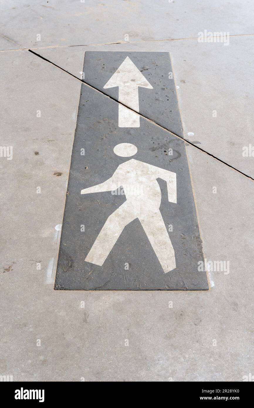 Close-up of walk sign on the concrete ground Stock Photo - Alamy