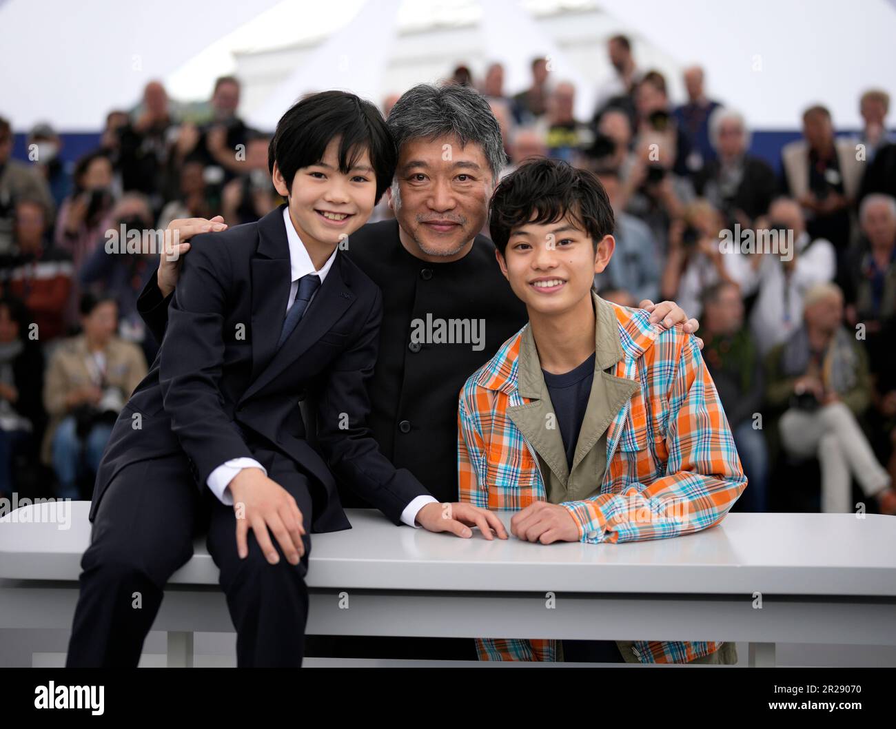 Hinata Hiiragi, from left, director Hirokazu Koreeda, and Soya Kurokawa pose for photographers ...