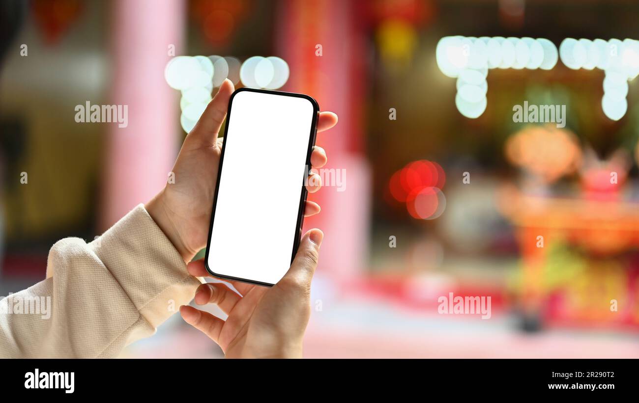 Woman holding smartphone hand temple hi-res stock photography and ...