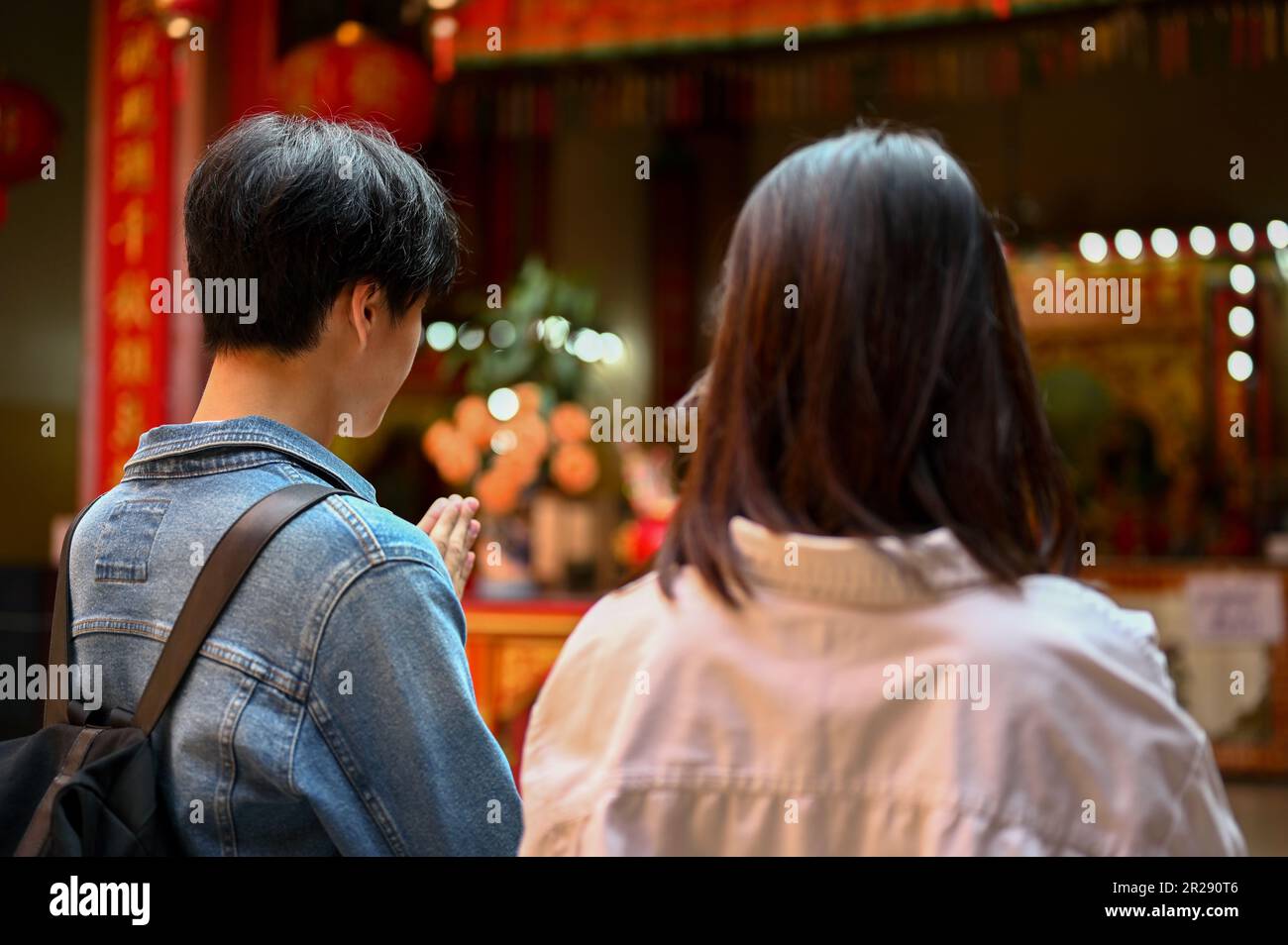 Young Asian couple visiting a Chinese temple to pray for their wishes ...
