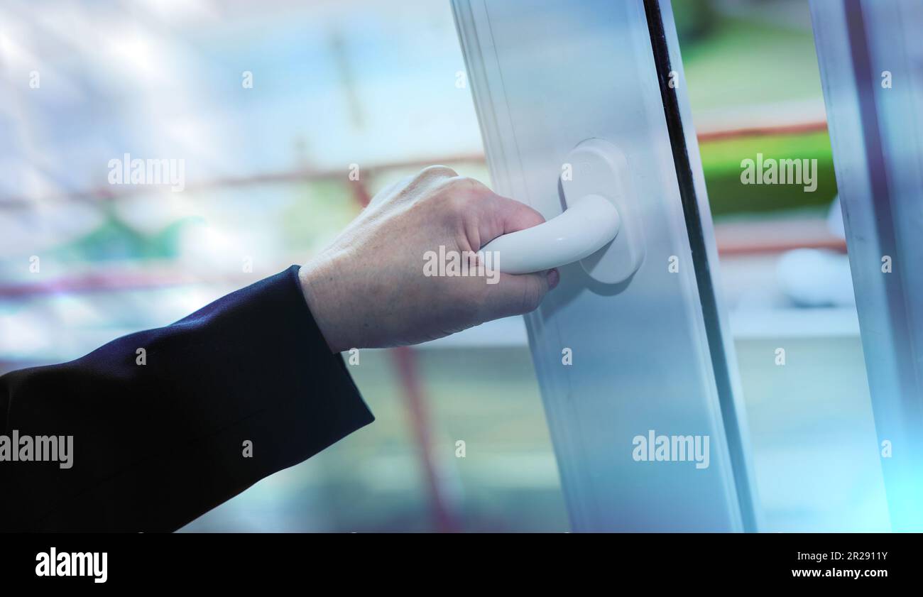 Female hand opening a window; light effect Stock Photo - Alamy