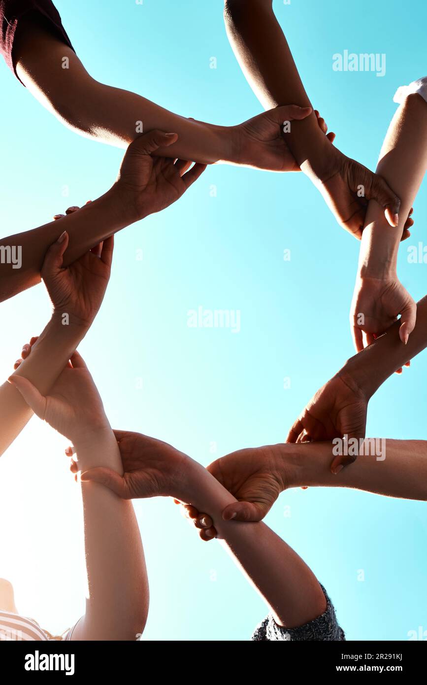 Hands, link and circle with teamwork and blue sky with low angle, solidarity and trust with arm ...