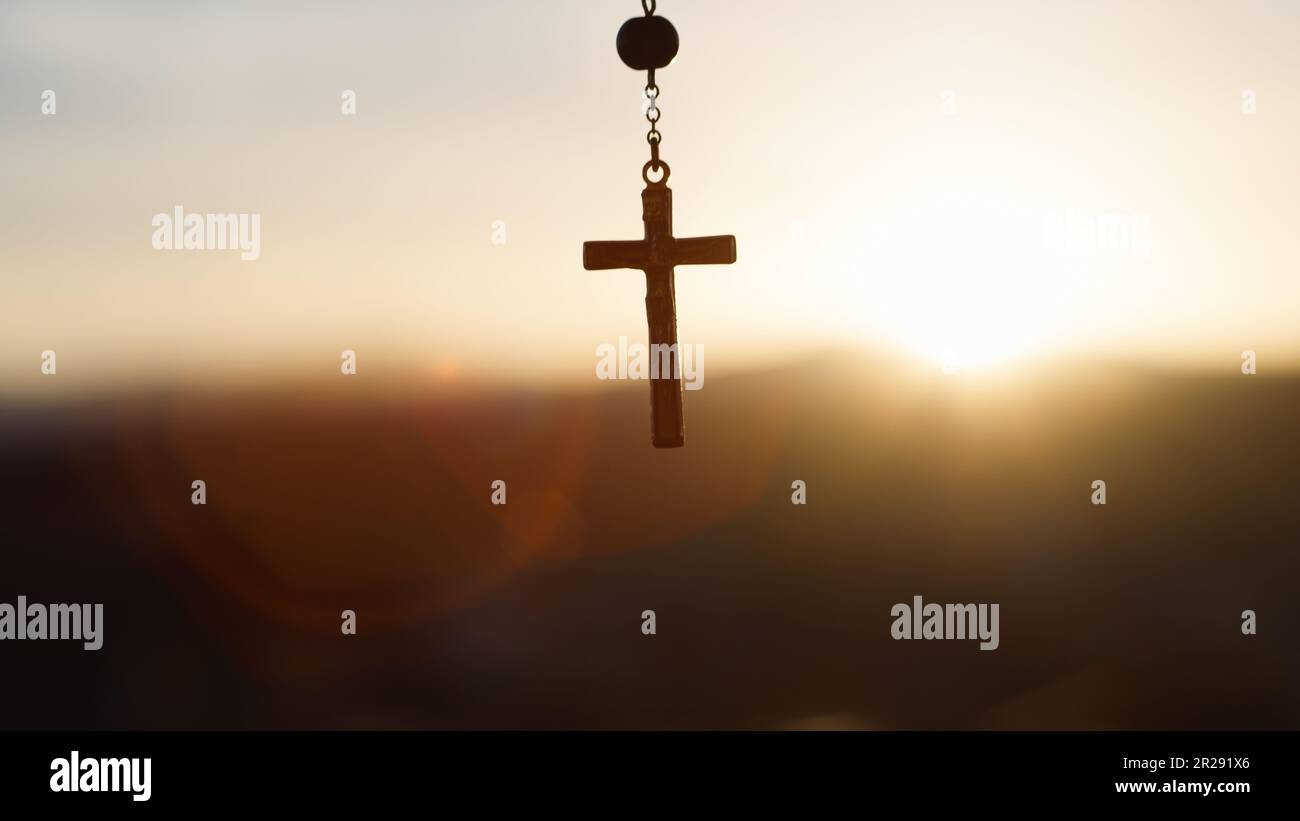 Rosary crucifix at sunset light Stock Photo - Alamy