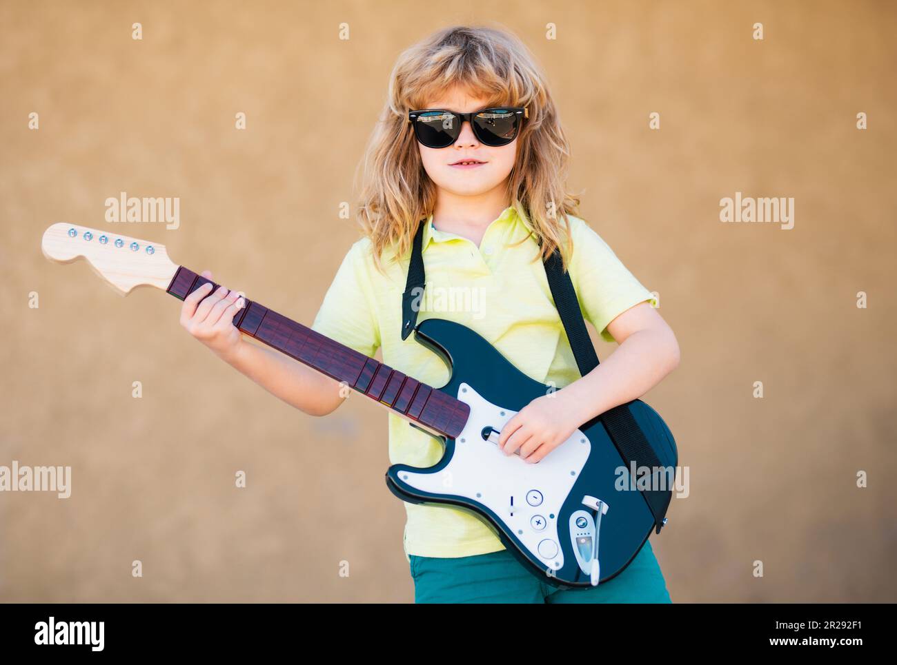 Child musician guitarist playing electric guitar. Music kids Stock ...