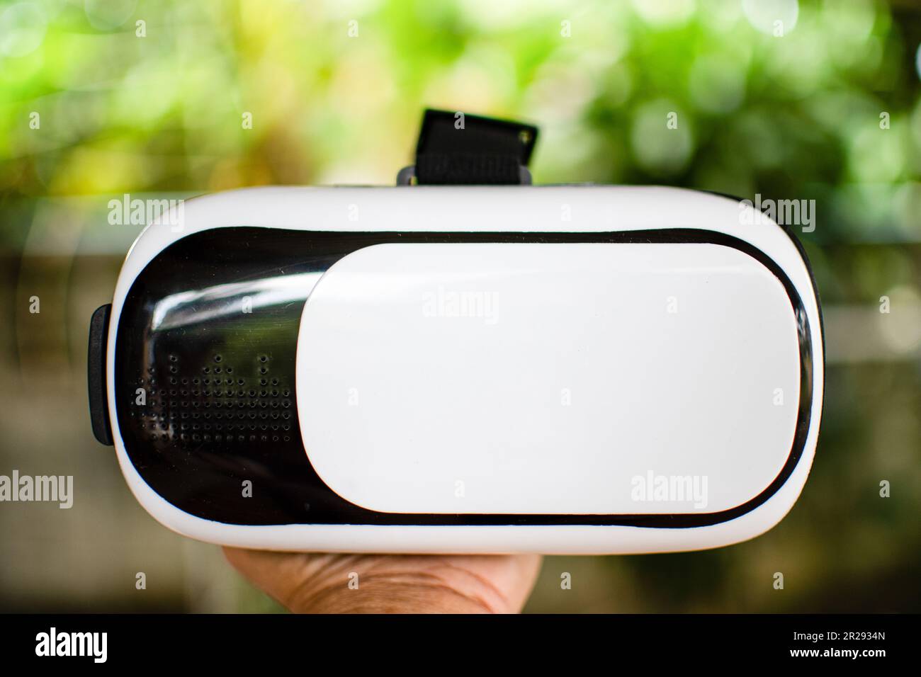 Male hand holding Virtual reality (VR) white and black. Man VR plays ...